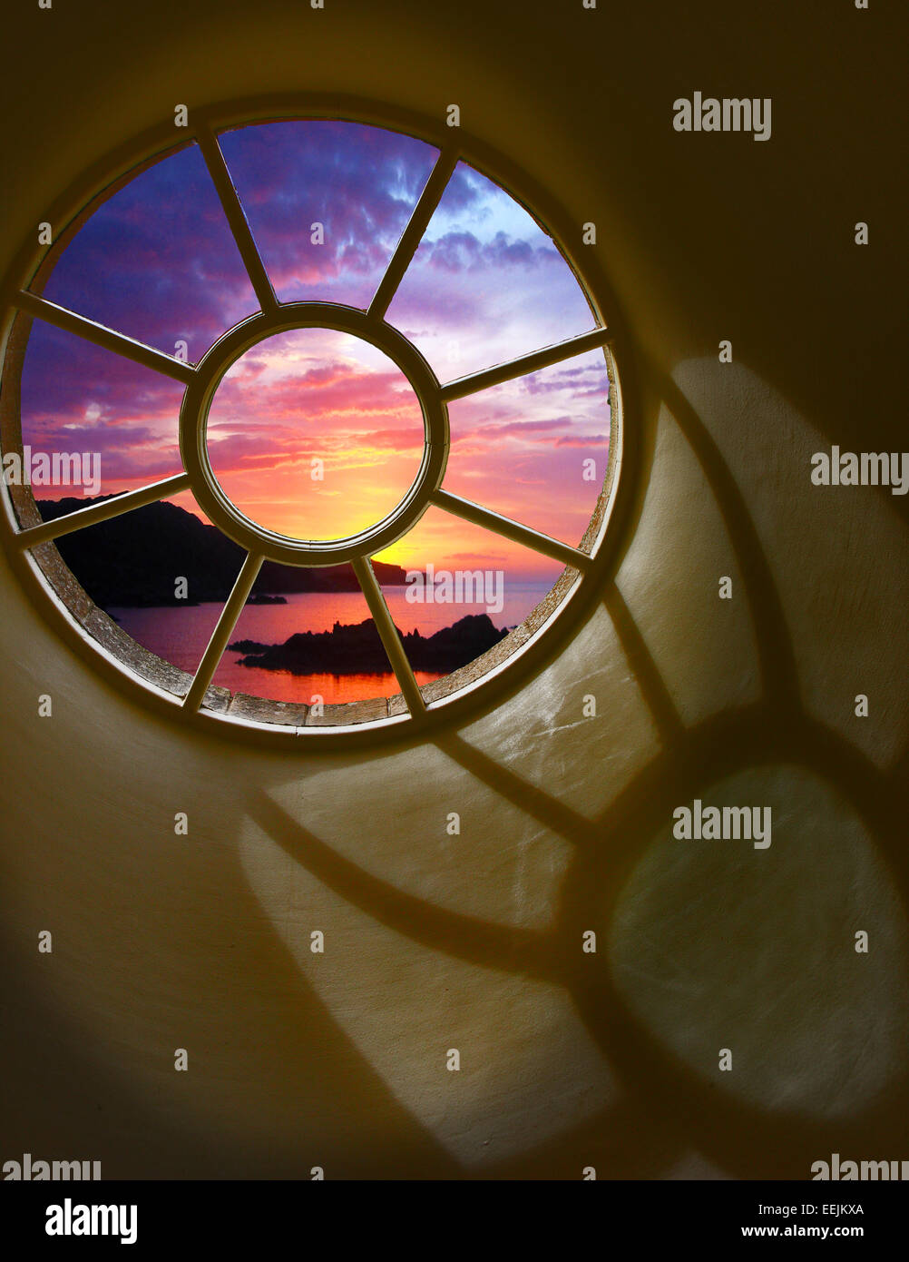 Round window with a view of beautiful sunset Stock Photo - Alamy