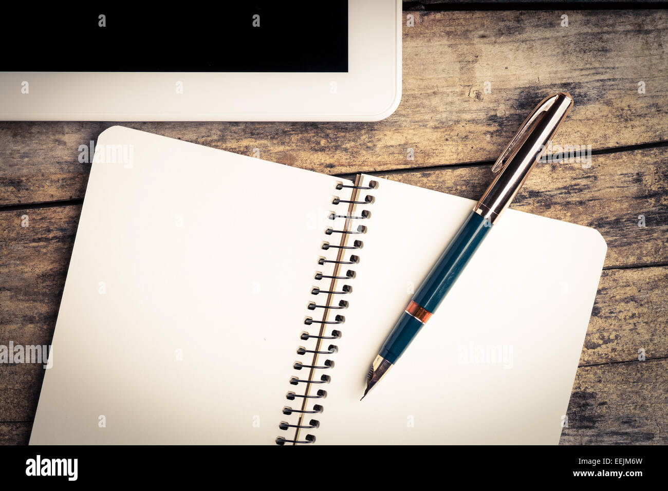 Vintage image of digital pad and old fountain with notebook at ...