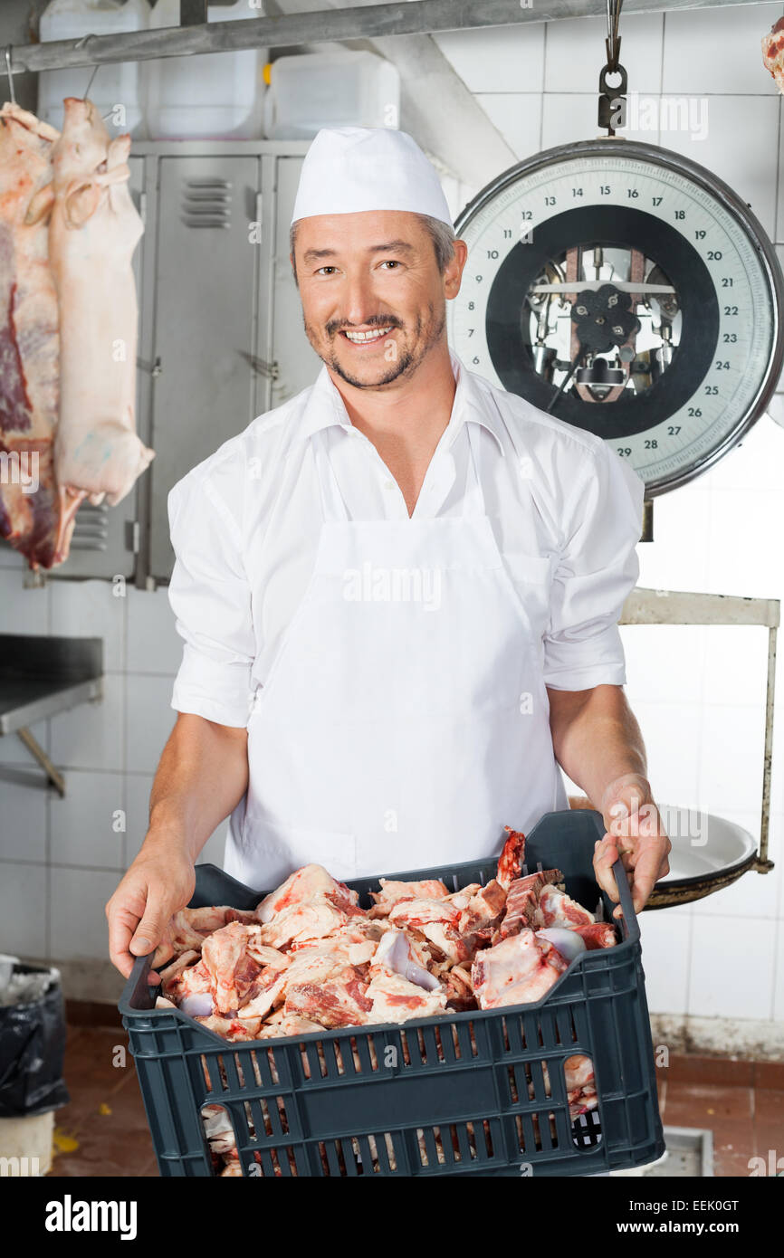 Butcher Carrying Crate Full Of Meat Pieces Stock Photo - Alamy