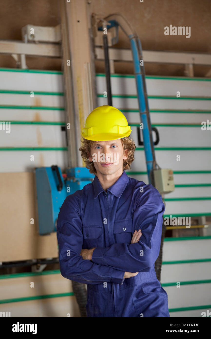 Confident Carpenter Against Vertical Saw Machine Stock Photo - Alamy