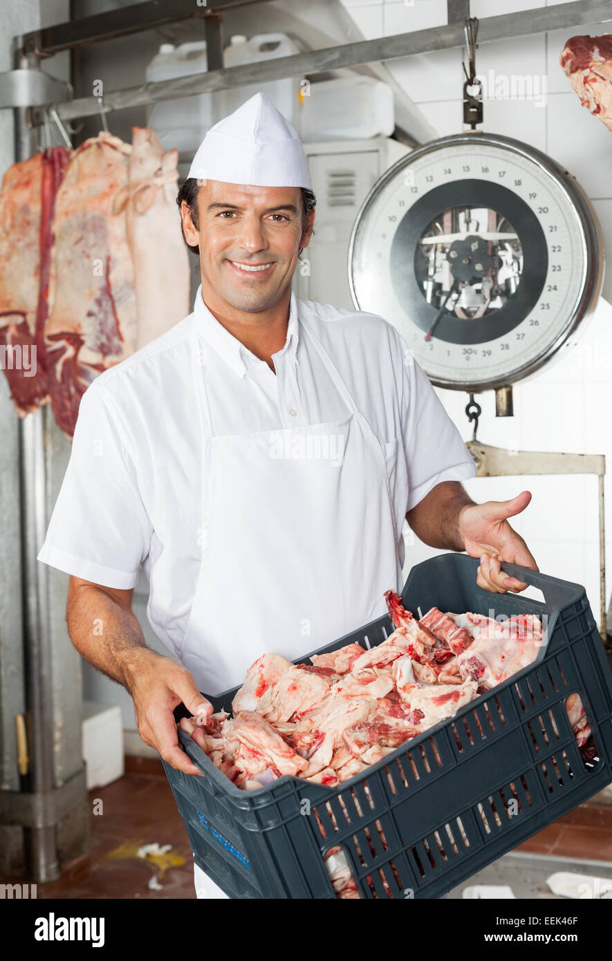 Butcher Carrying Crate Full Of Meat Pieces Stock Photo - Alamy
