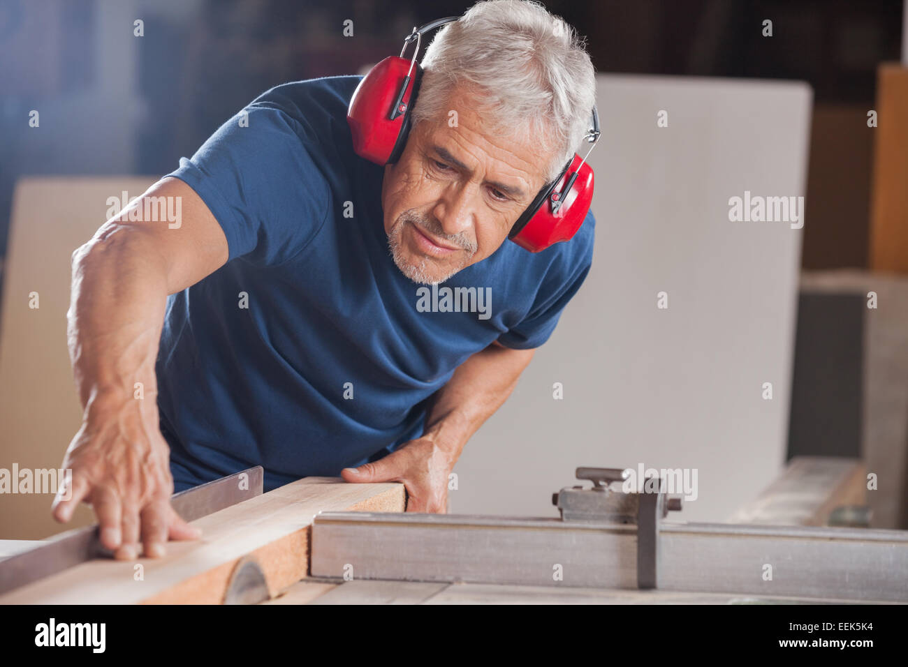 Male Carpenter Cutting Wood With Tablesaw Stock Photo - Alamy