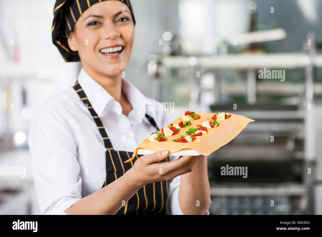 Cheerful Chef Holding Tray With Stuffed Pasta Sheet Stock Photo - Alamy