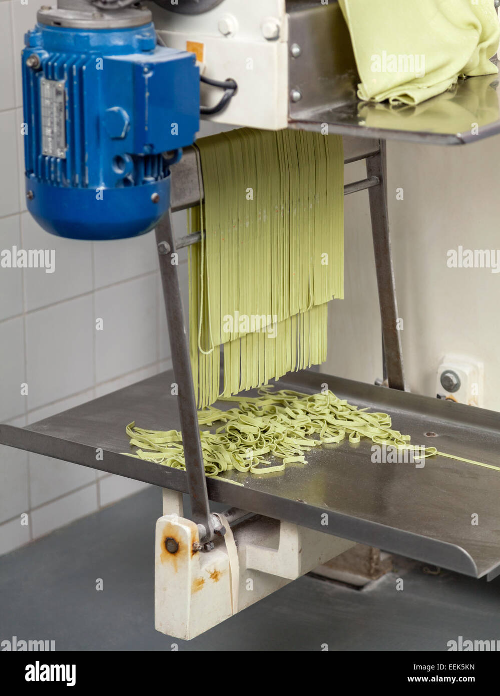Green Spaghetti Pasta Being Processed In Machine Stock Photo - Alamy