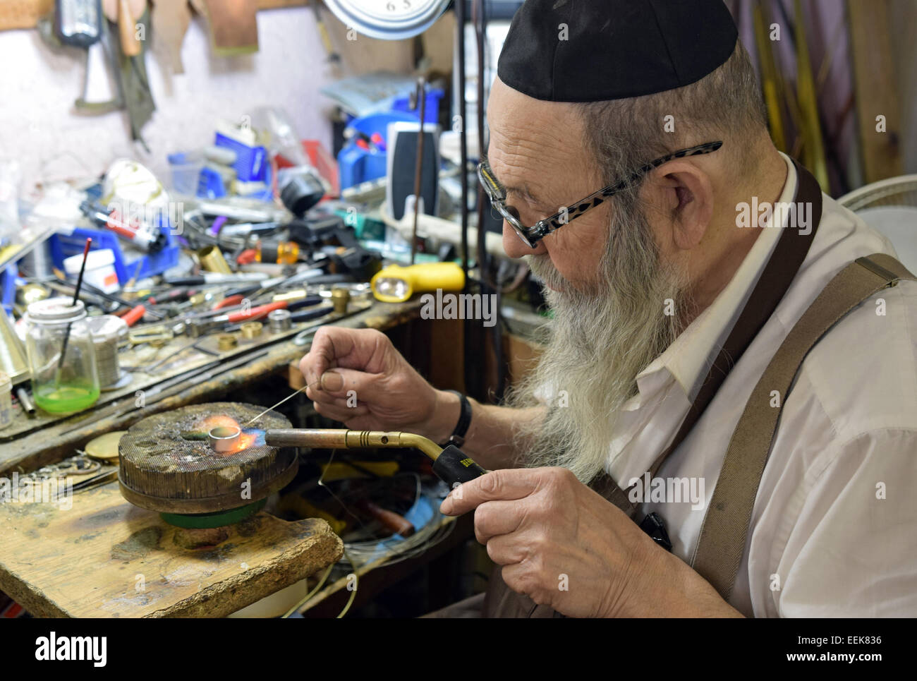Portrait of religious Jewish silversmith & metalworker in his studio ...