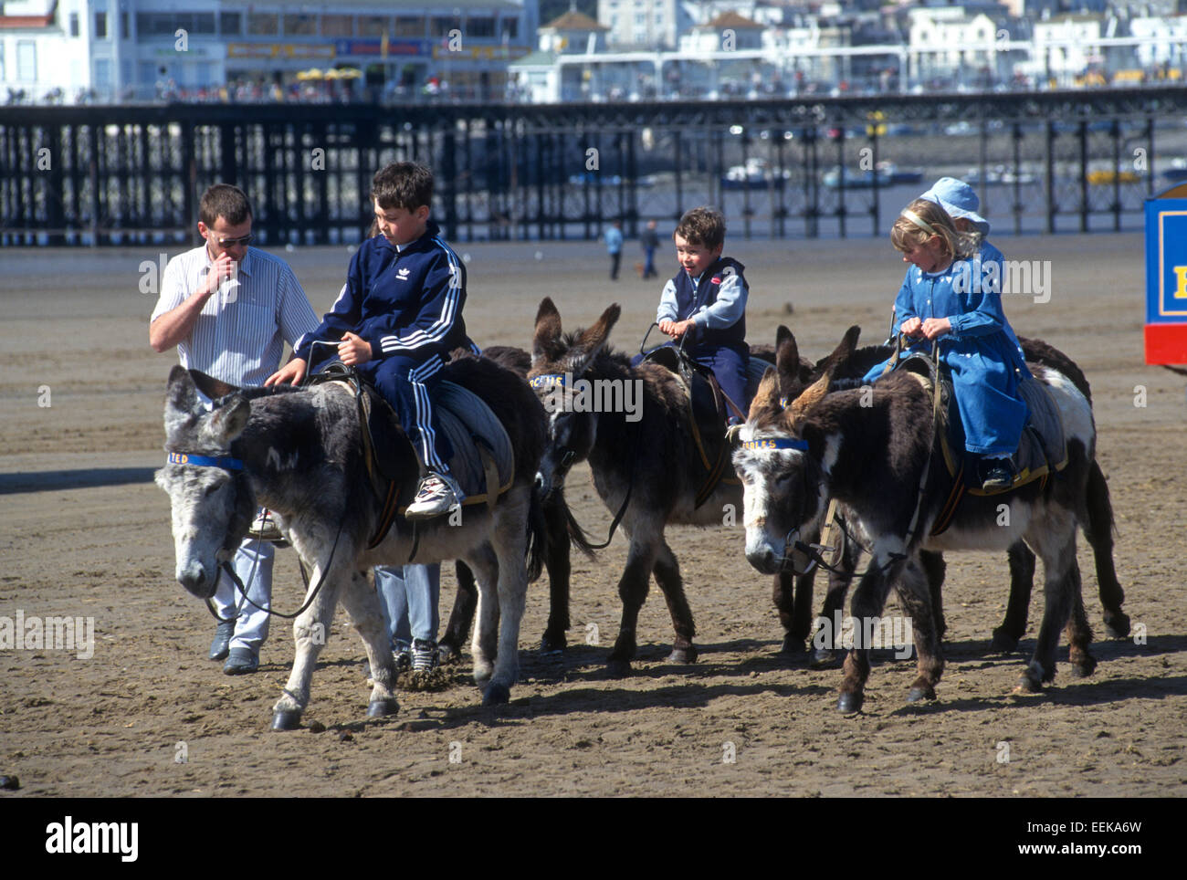 Children riding donkeys on the beach at Weston Super Mare UK Stock ...