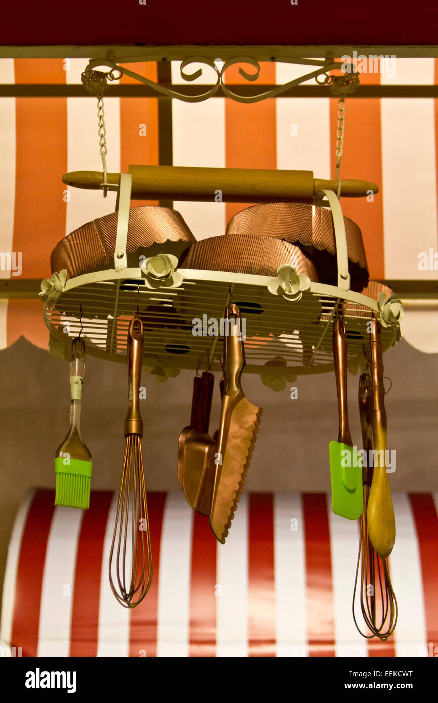 Cooking tools hanging with colorful background Stock Photo - Alamy