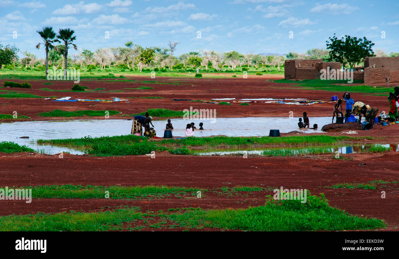 People bathing and washing clothes in a natural water pool, Mali Stock ...