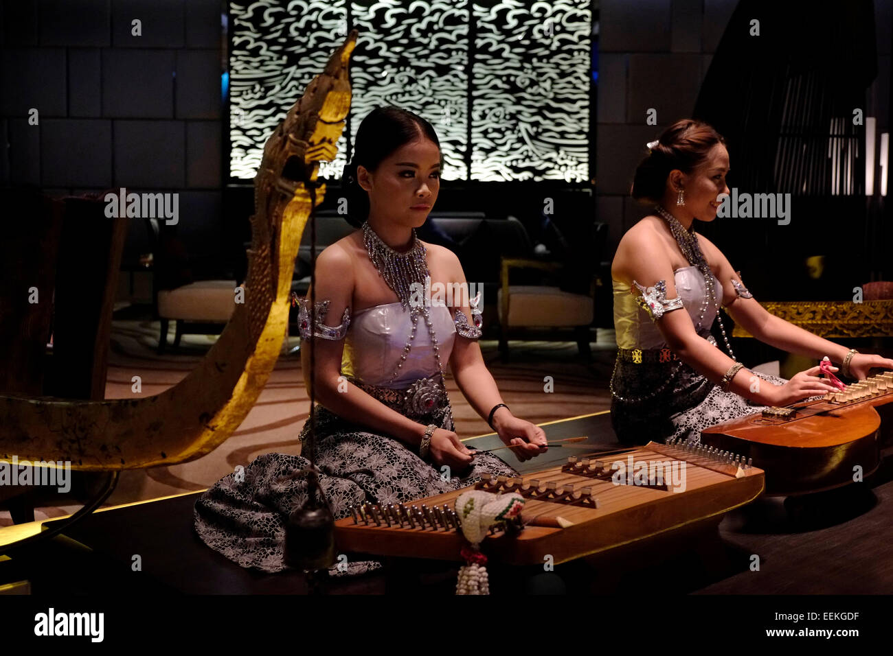 Young Thai women playing the Khim a wooden hammered dulcimer traditional music instrument from ...