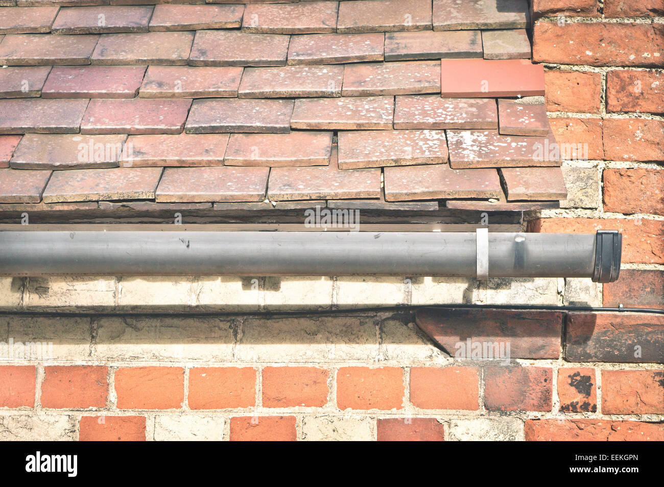 The end of a gutter on an old red brick building Stock Photo - Alamy