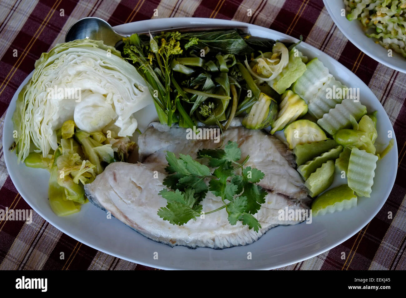 Tilapia fish fillet, cut into wide stripes with mixed herbs. Northern ...