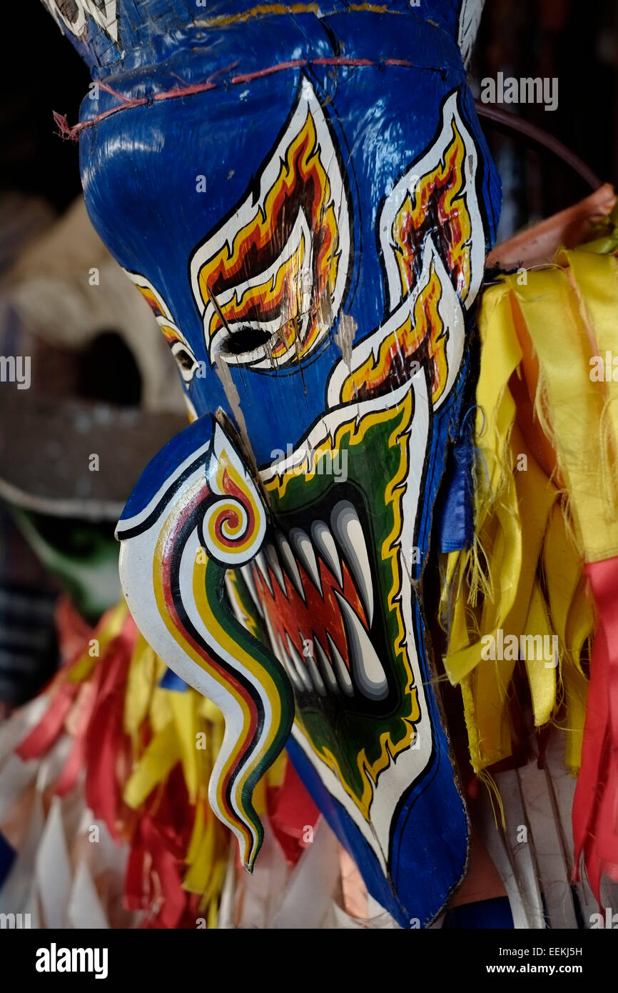 A traditional Phi Ta Khon mask made from carved coconut tree trunk ...