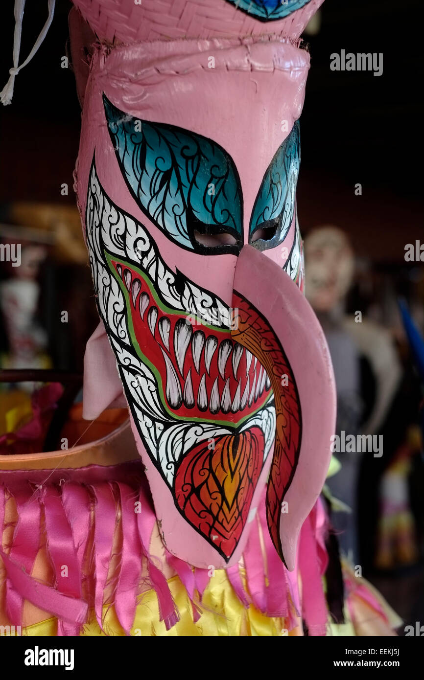 A traditional Phi Ta Khon mask made from carved coconut tree trunk ...