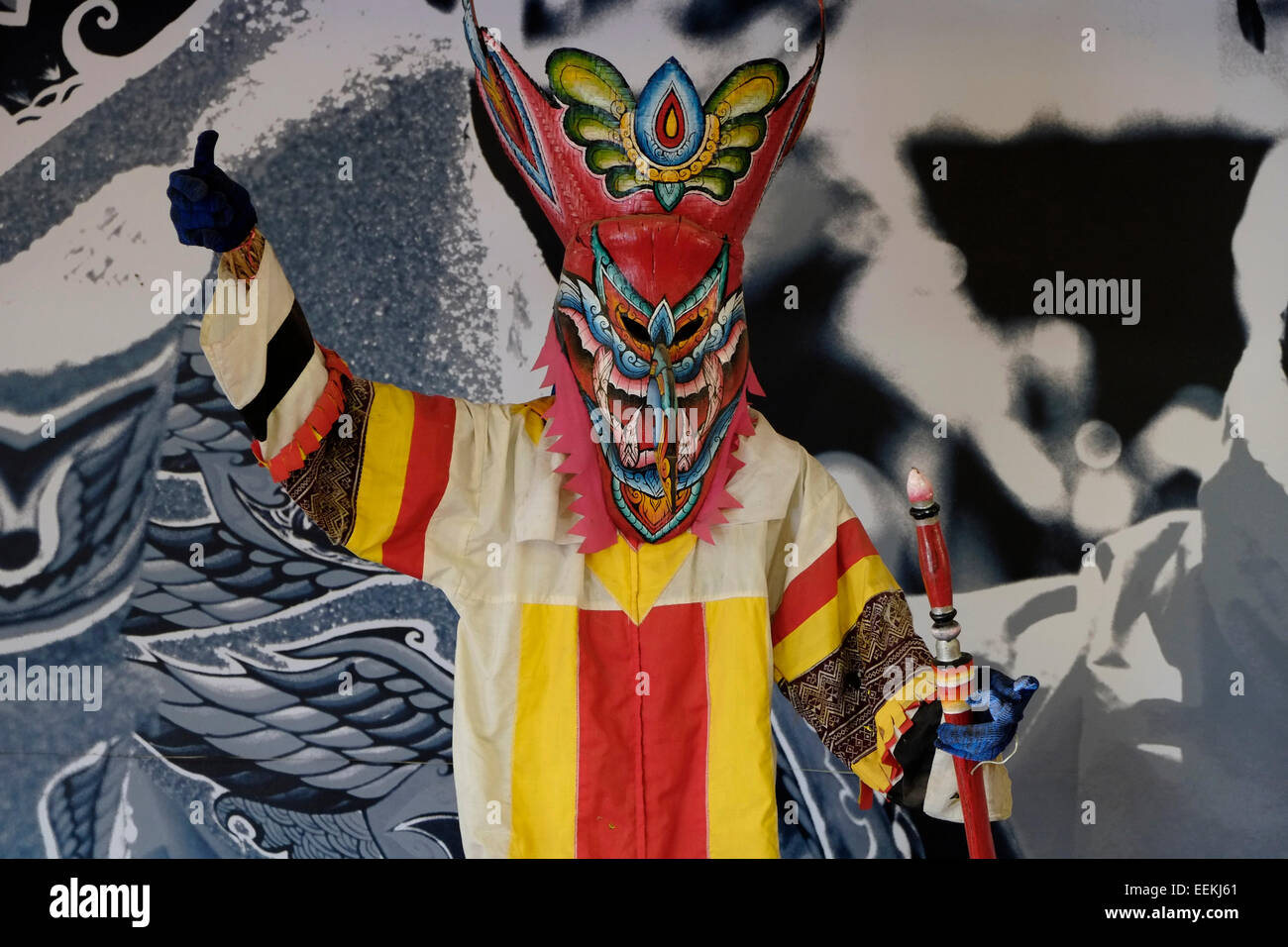 Traditional Phi Ta Khon mask made from carved coconut tree trunk which ...