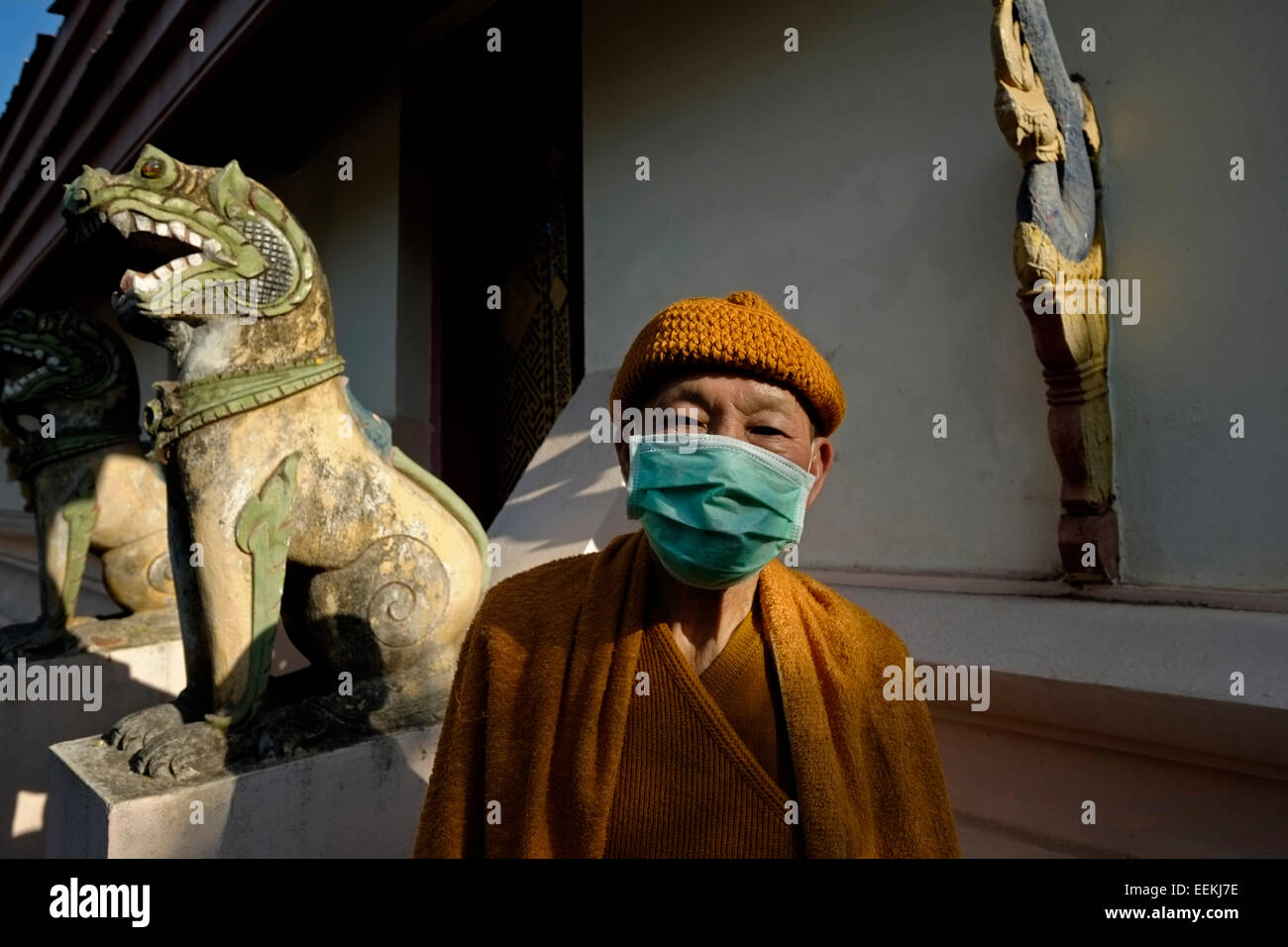 A Buddhist monk wearing a surgical mask at Sri Khun Muane temple in the ...