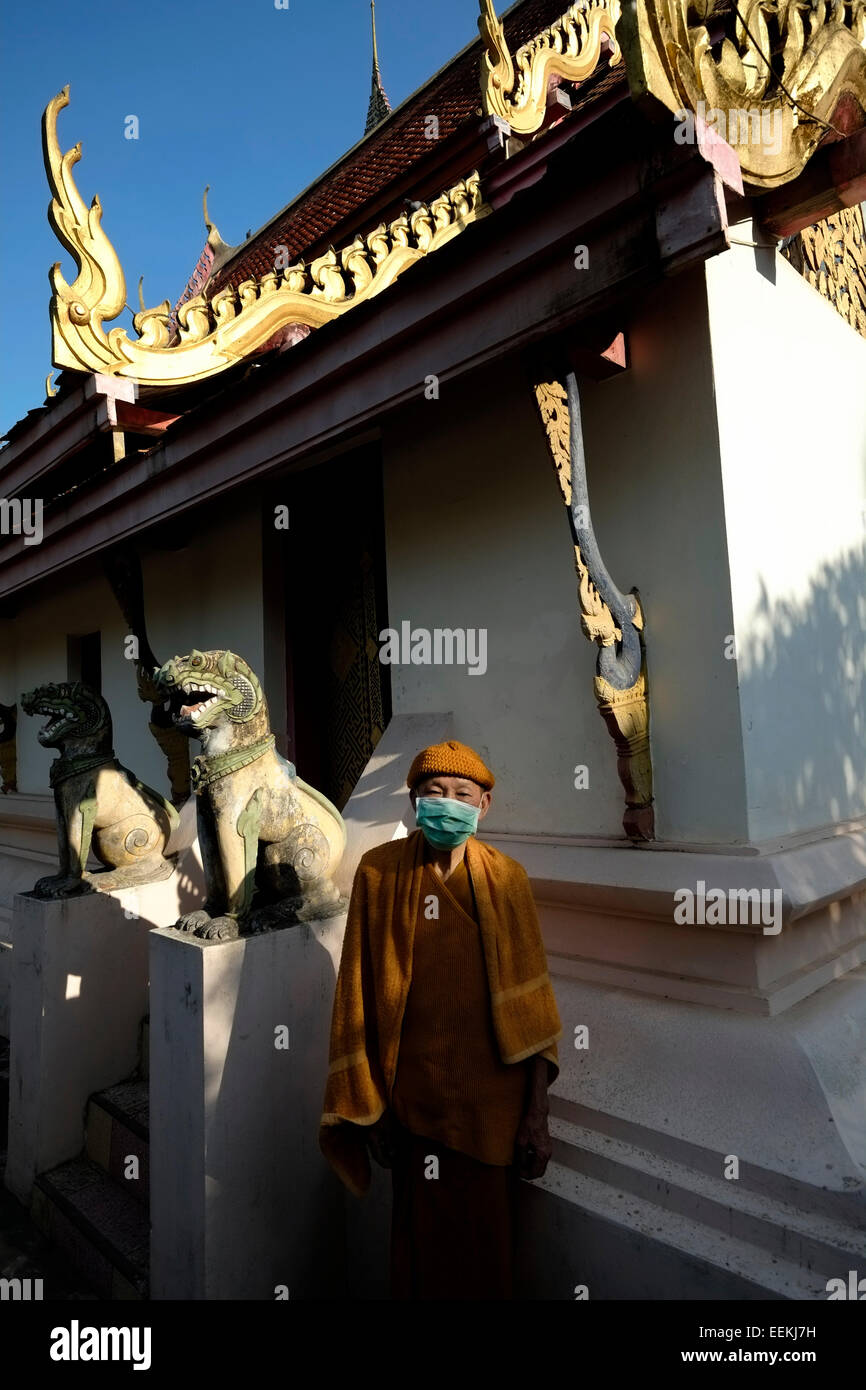 A Buddhist monk wearing a surgical mask at Sri Khun Muane temple in the ...