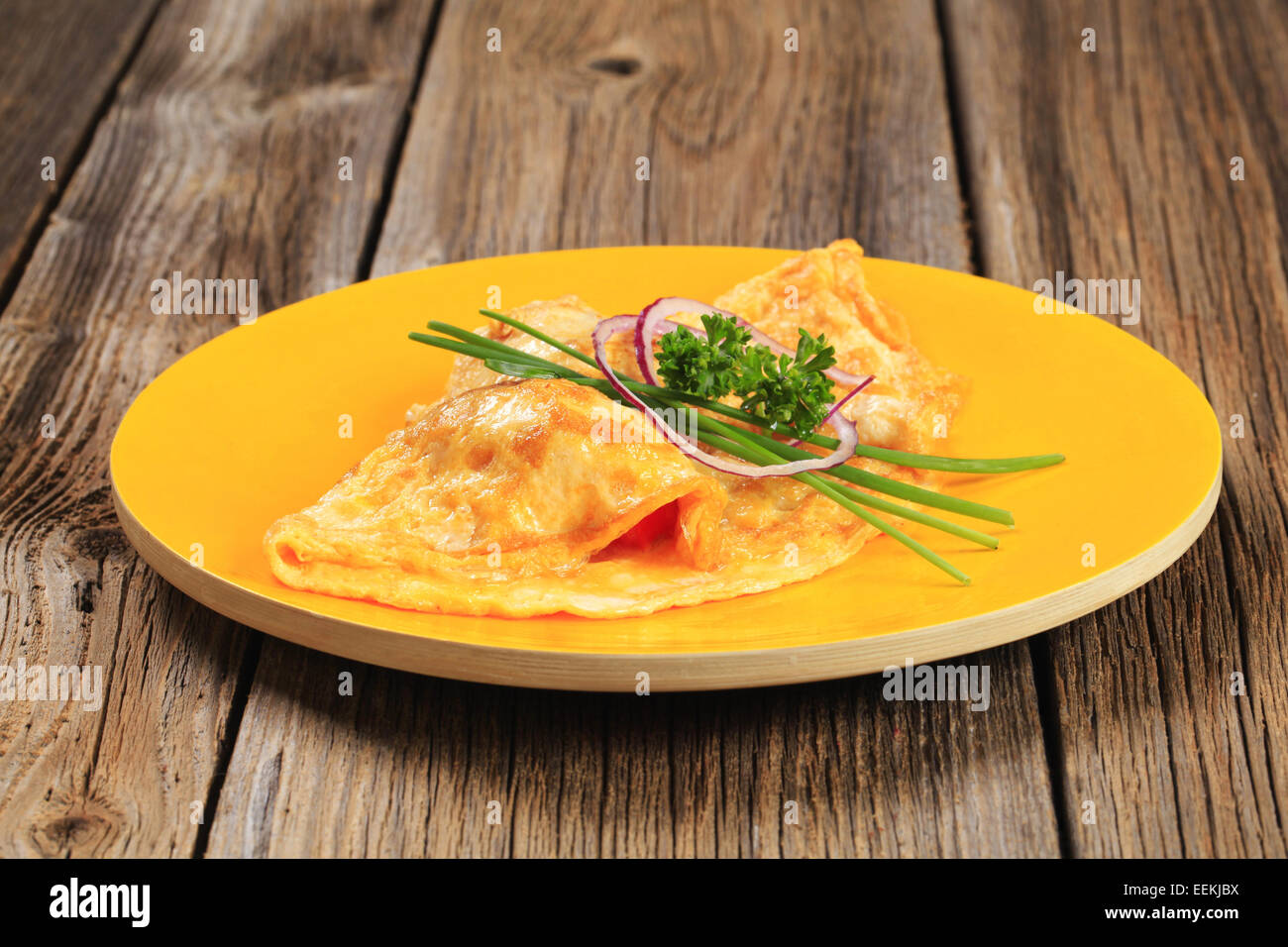 Egg omelet on yellow plate Stock Photo - Alamy