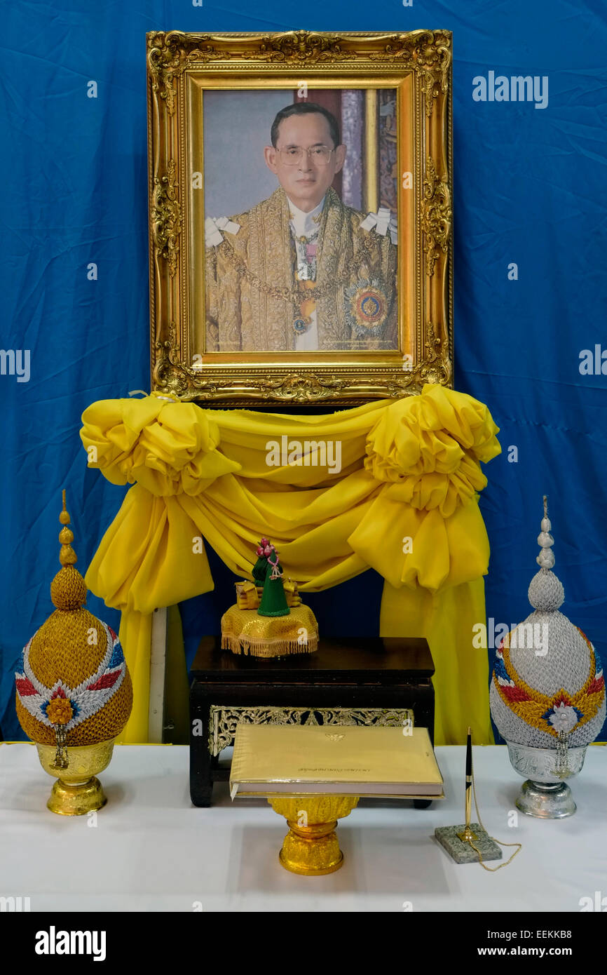 Gold framed image of King Bhumibol Adulyadej Rama IX displayed behind ...