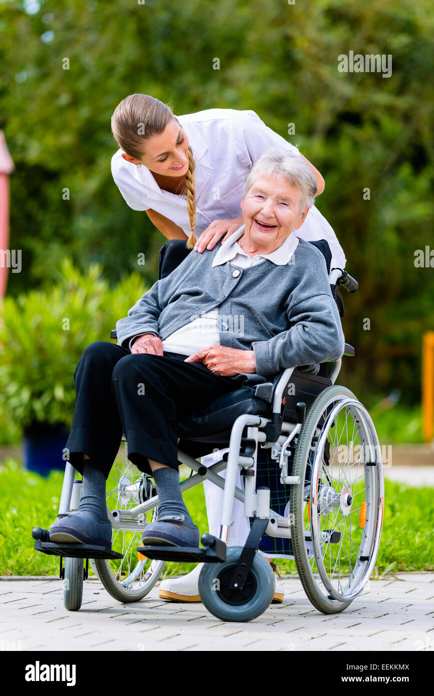 Pushing wheelchair hi-res stock photography and images - Alamy