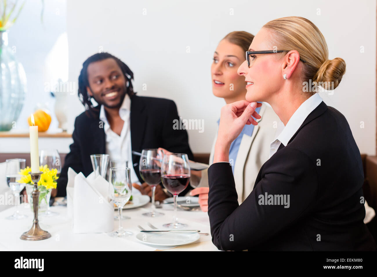 business lunch Team meeting in restaurant eating and drinking in ...