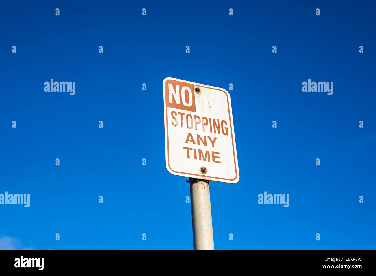 No Stopping Any Time warning sign against a blue sky Stock Photo - Alamy
