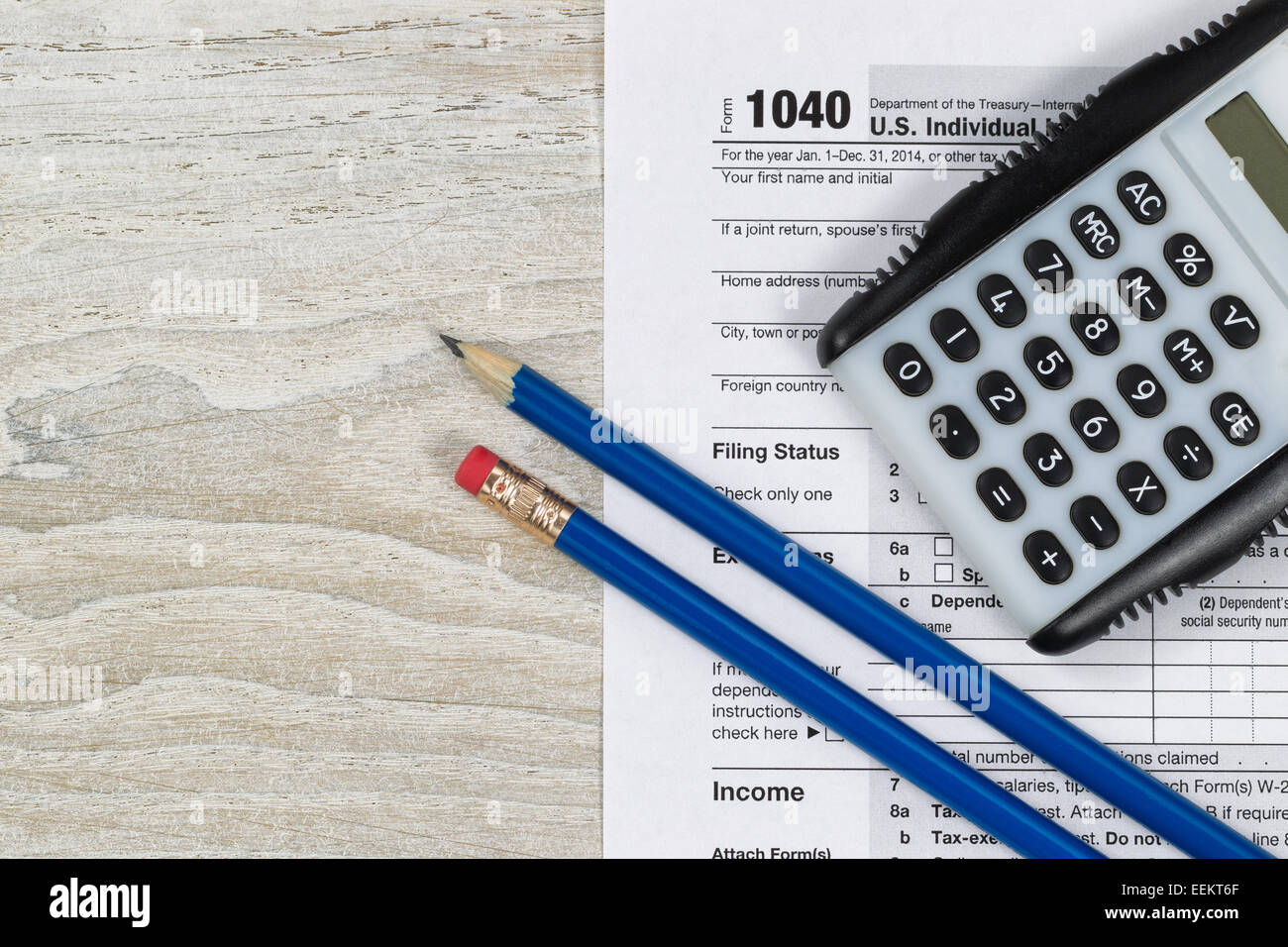 U.S. Tax form 1040 with calculator and pencils on wooden desktop Stock ...