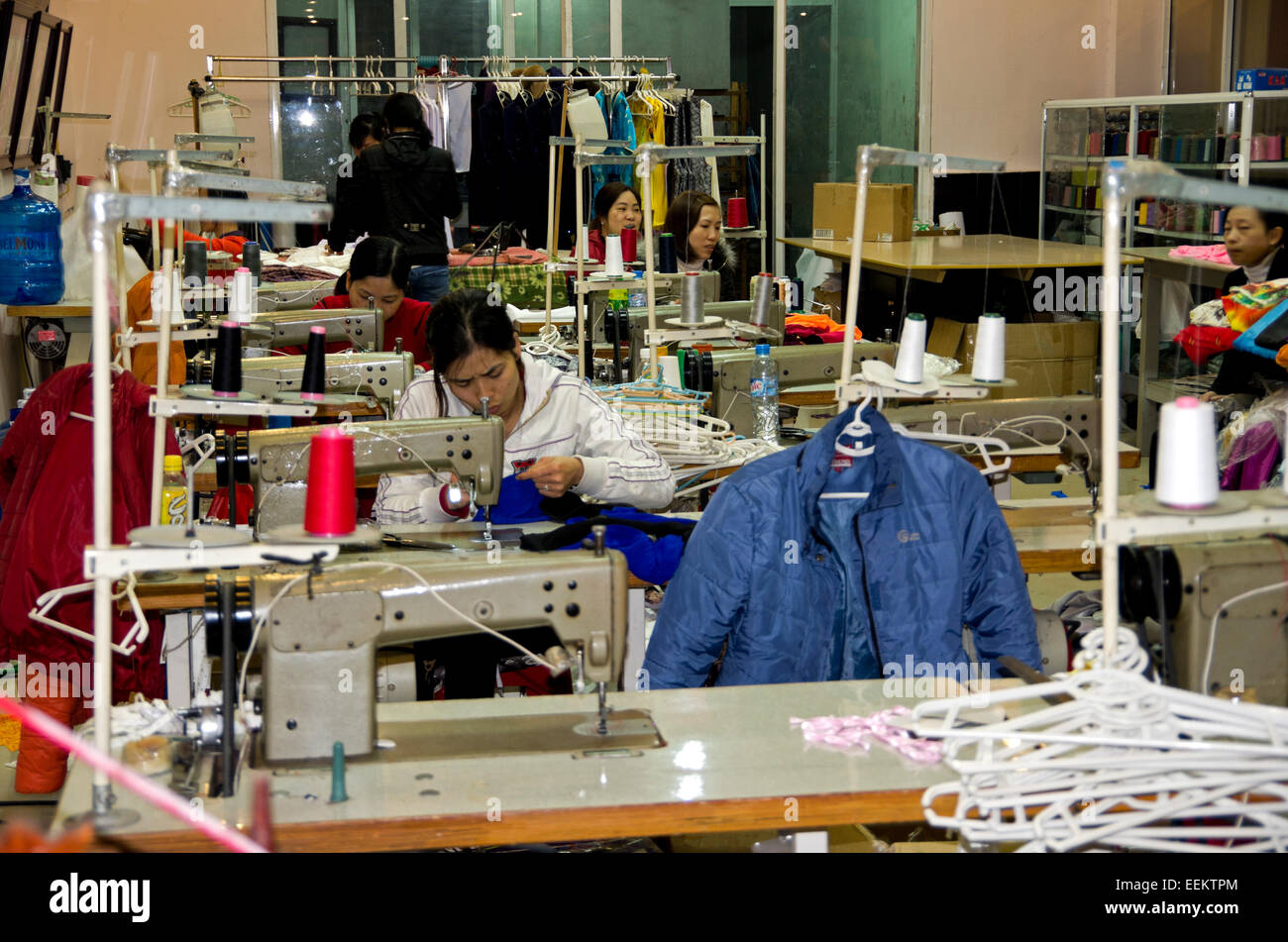 Women making clothes on sewing machines in roadside tourist stop ...