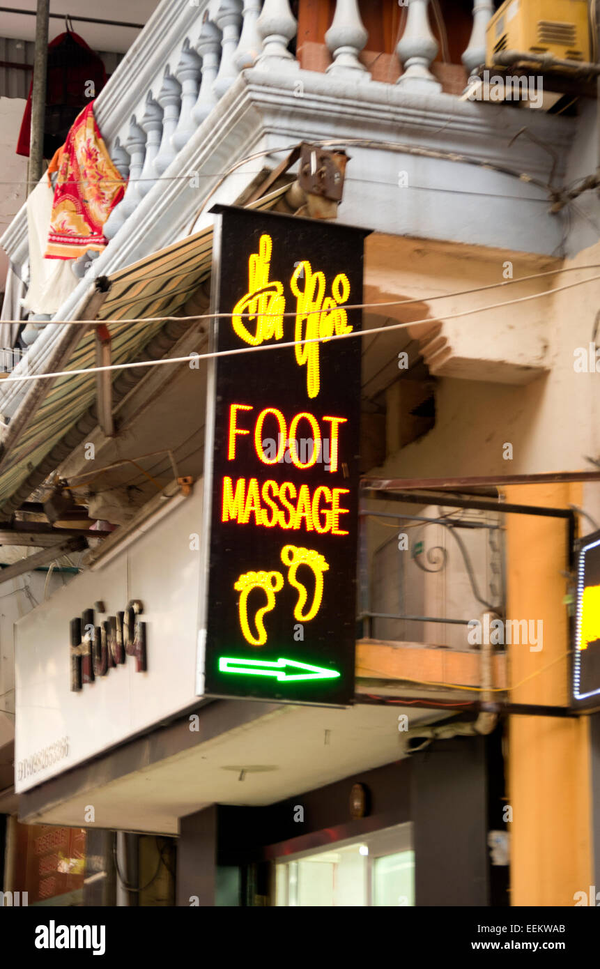 "Foot Massage" sign, yellow neon letters, hangs off balcony Stock Photo ...