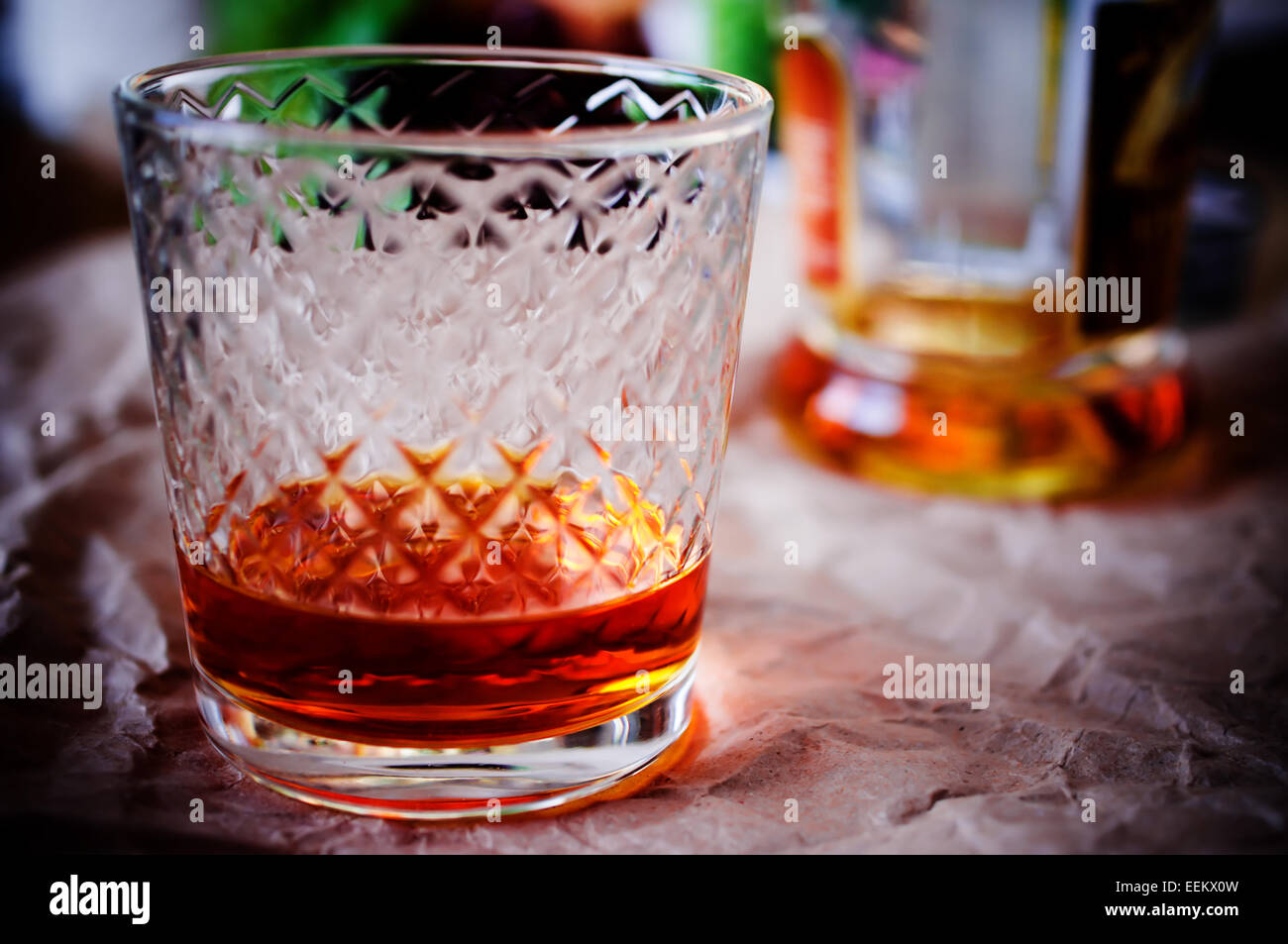 Shot with cognac, brandy on the table in dim lighting Stock Photo - Alamy