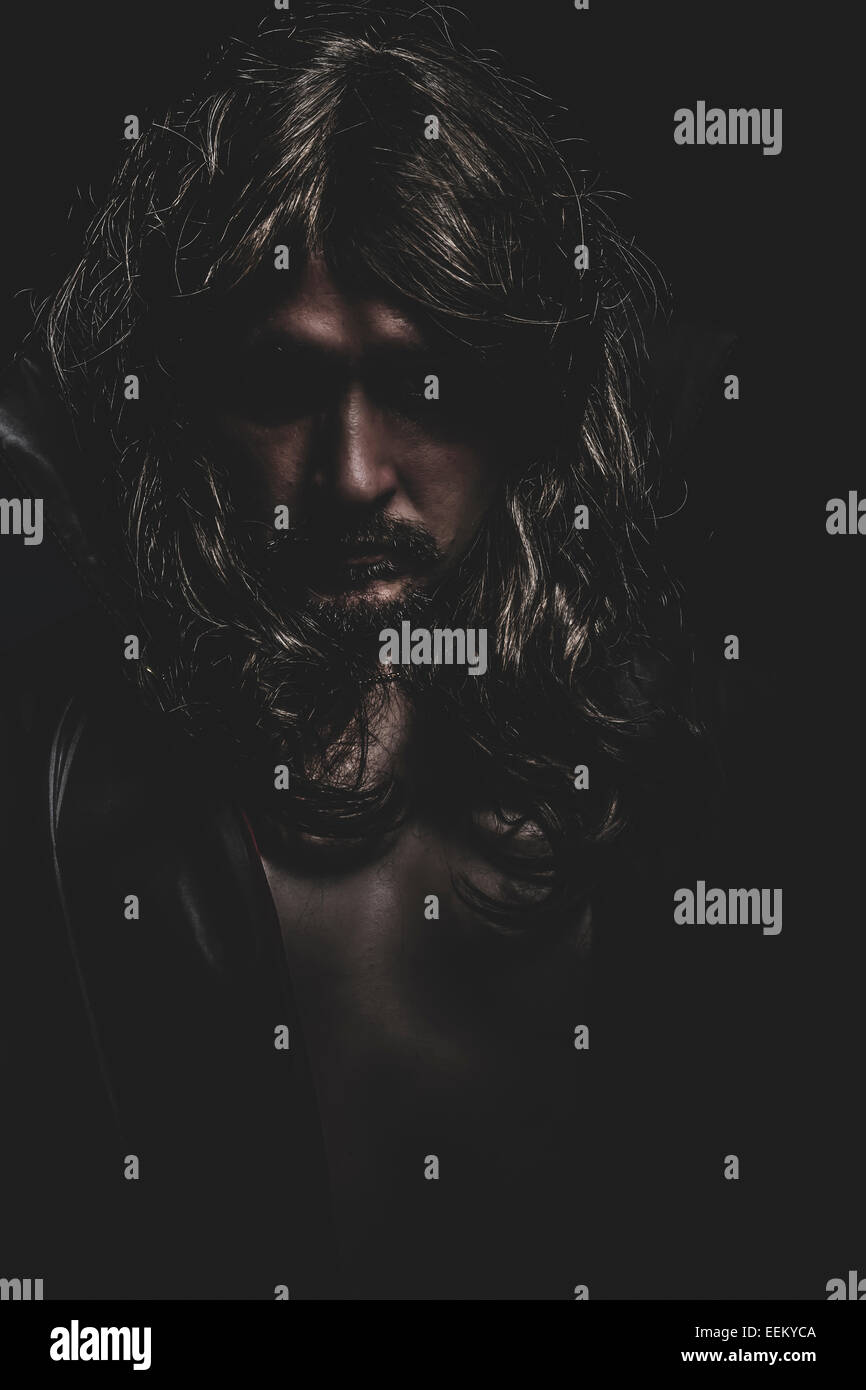 Vampire with black coat and long hair, sad Stock Photo - Alamy