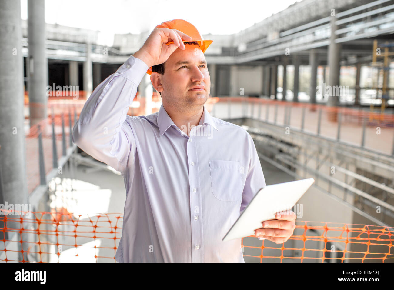 A foreman with digital tablet supervising the project at the ...