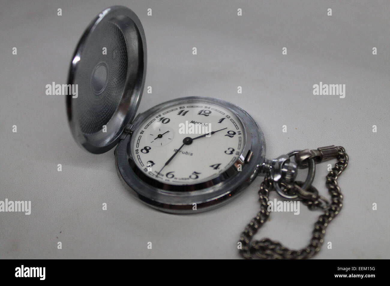 beautiful silver pocket clock with open top and thin shine chain Stock ...