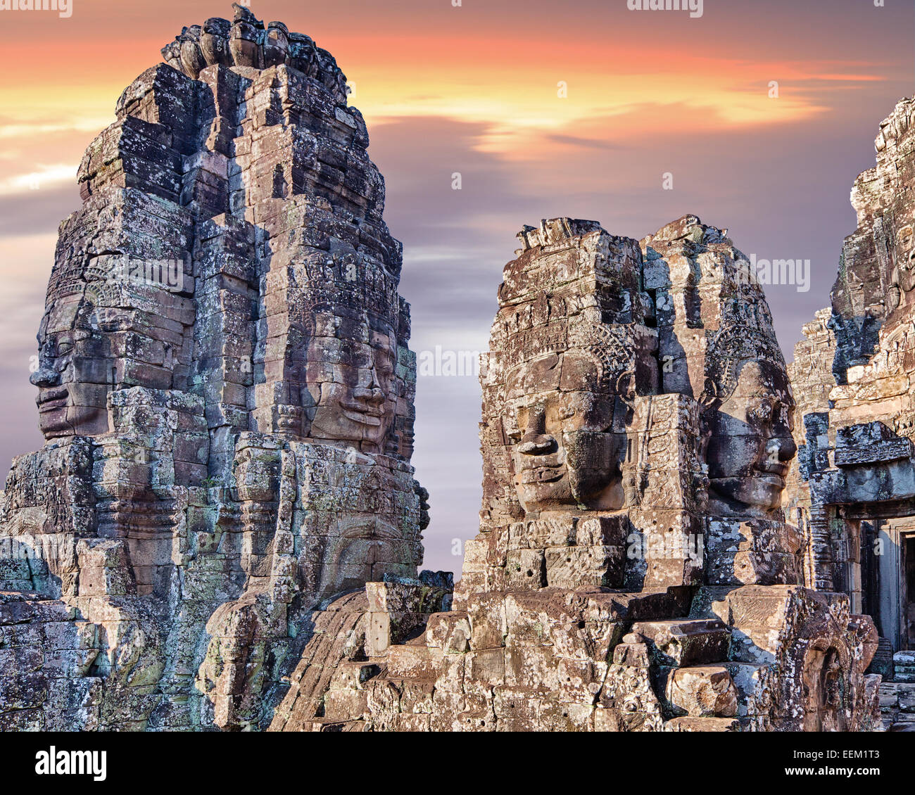 Bayon temple statues carving of the faces on sunset sunrise Stock Photo ...