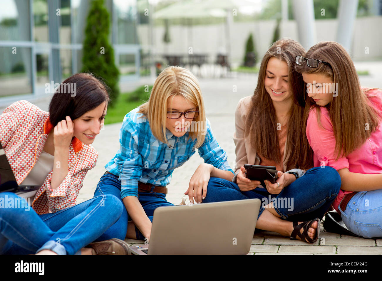 Young and happy girlfriends or classmates having fun at the School or ...