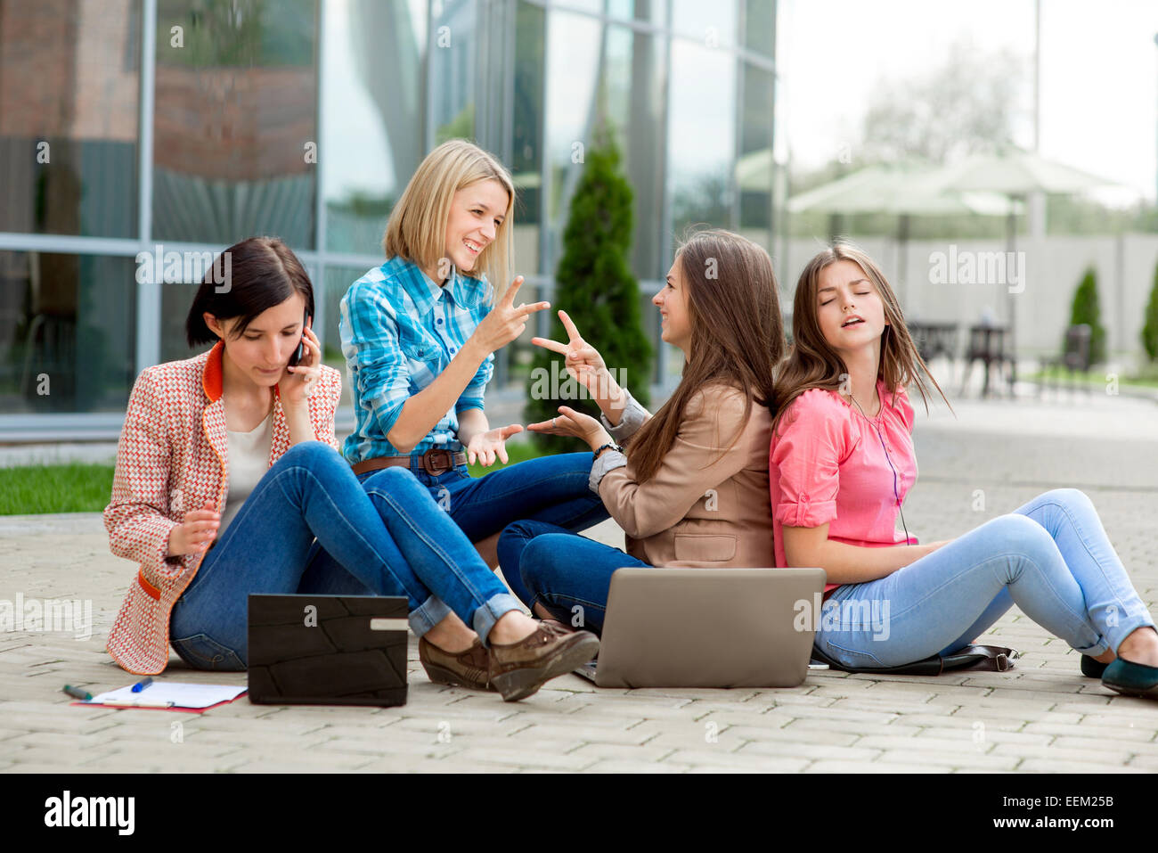 Young and happy girlfriends or classmates having fun at the School or ...