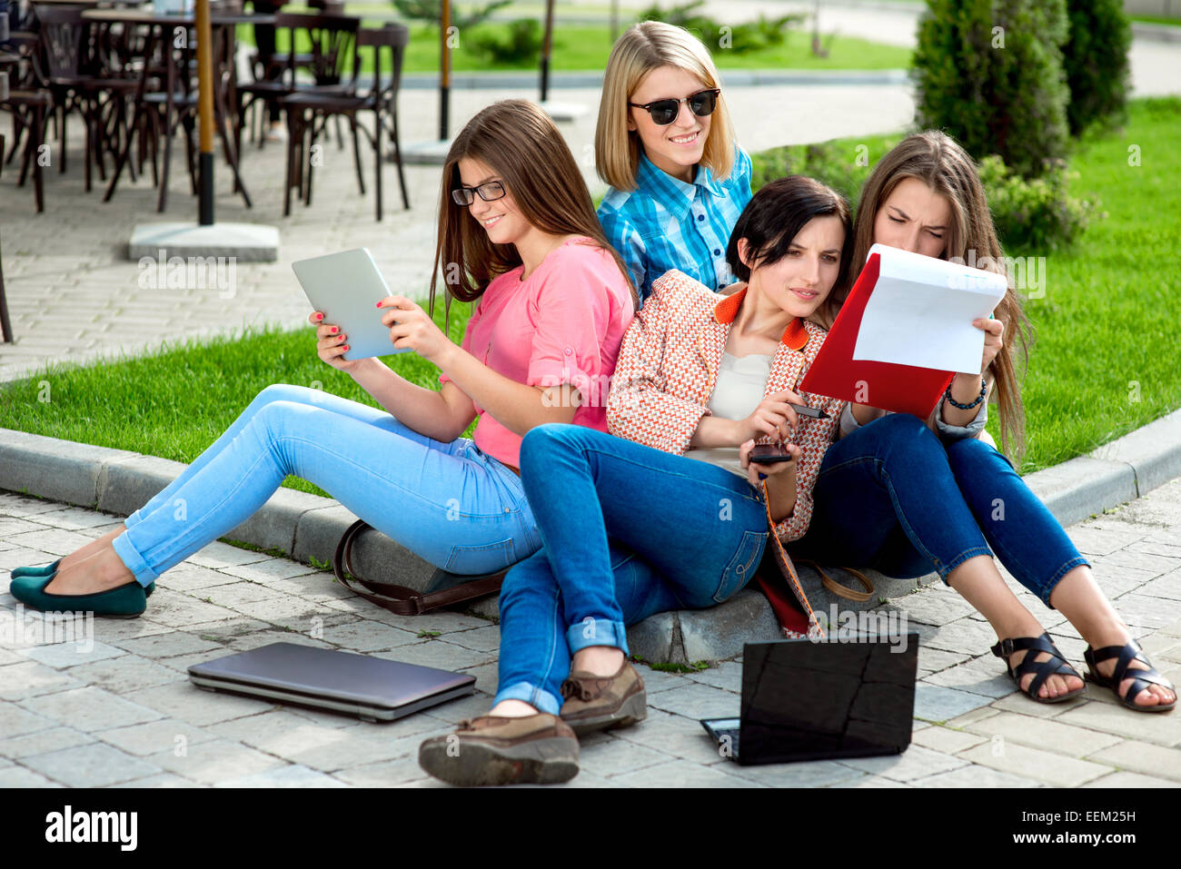 Young and happy girlfriends or classmates having fun at the School or ...