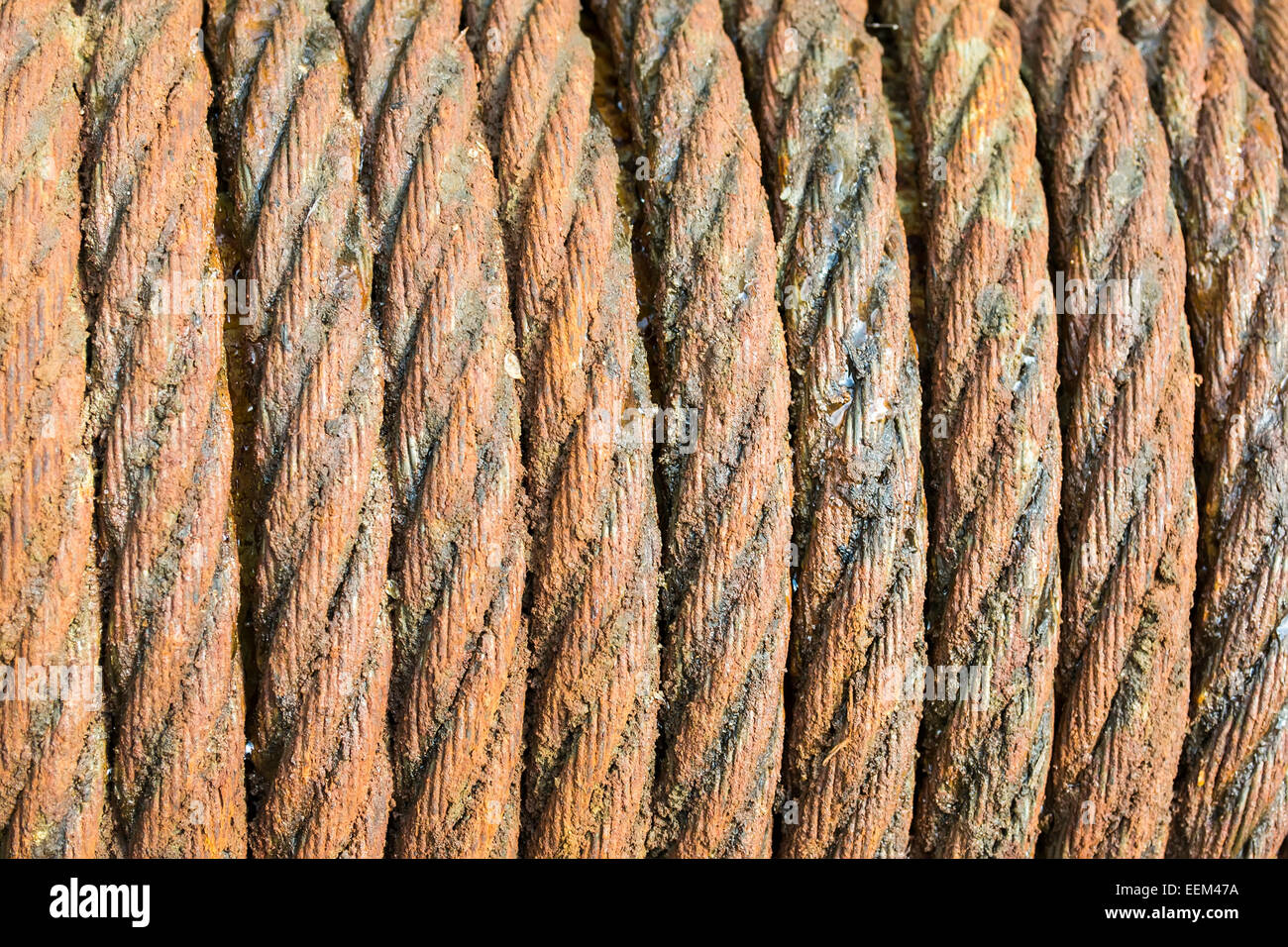 Rusty heavy duty steel cable rolled on a cylinder, background Stock ...