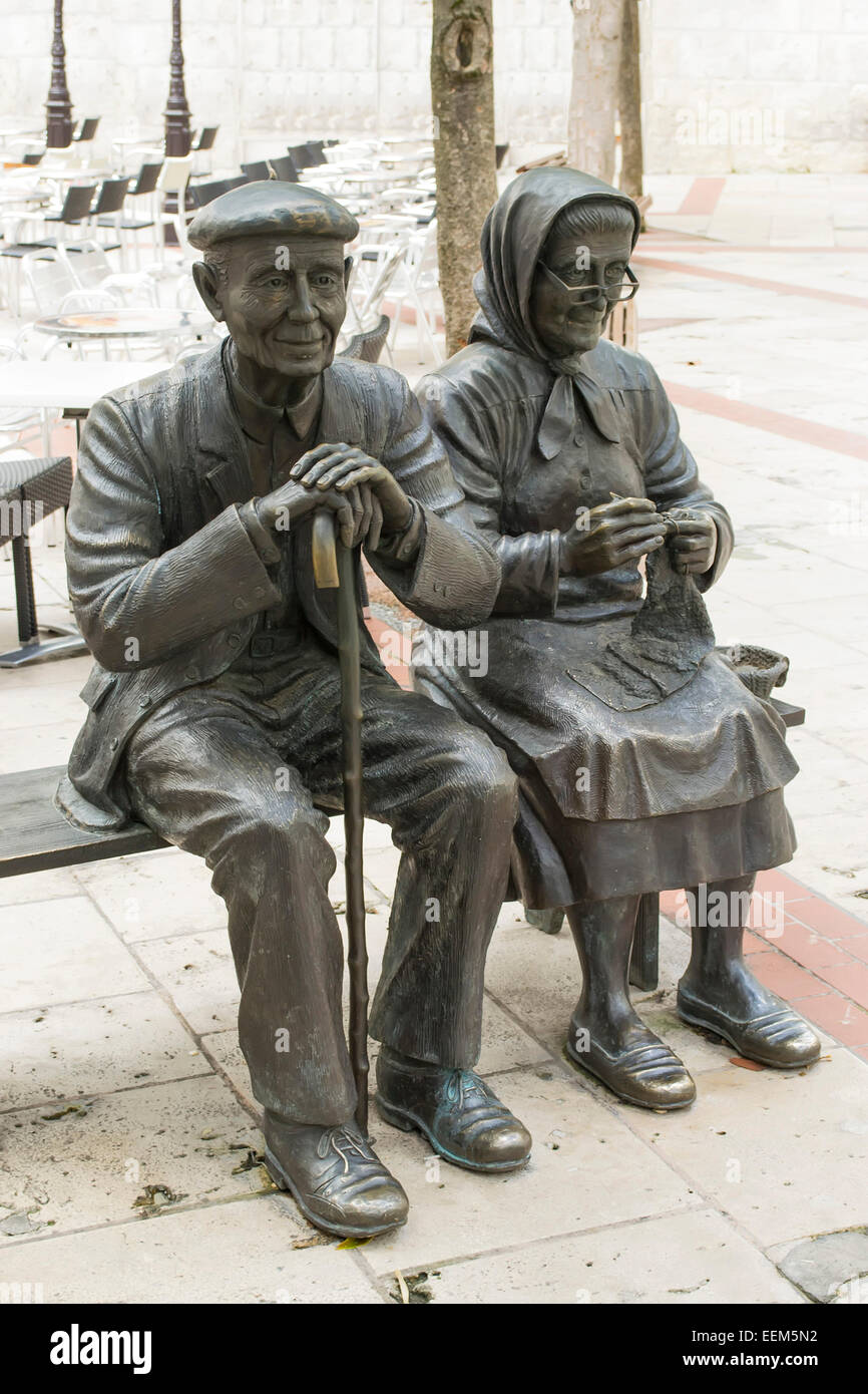 Two bronze statues representing an old couple, husband and wife in ...