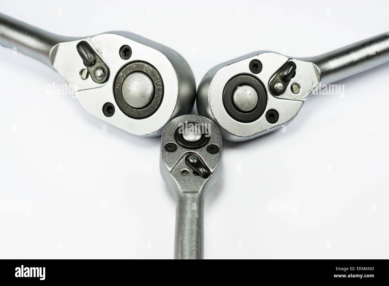 Three ratchets of different sizes placed head to head at an even angle ...