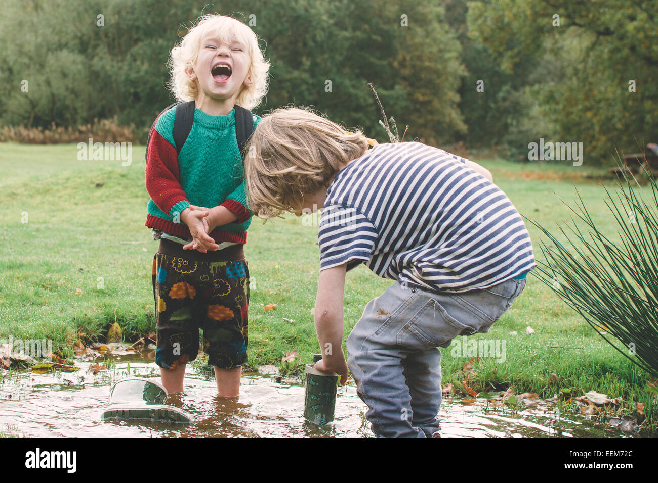 Children (2-3, 4-5) having fun in puddle Stock Photo - Alamy