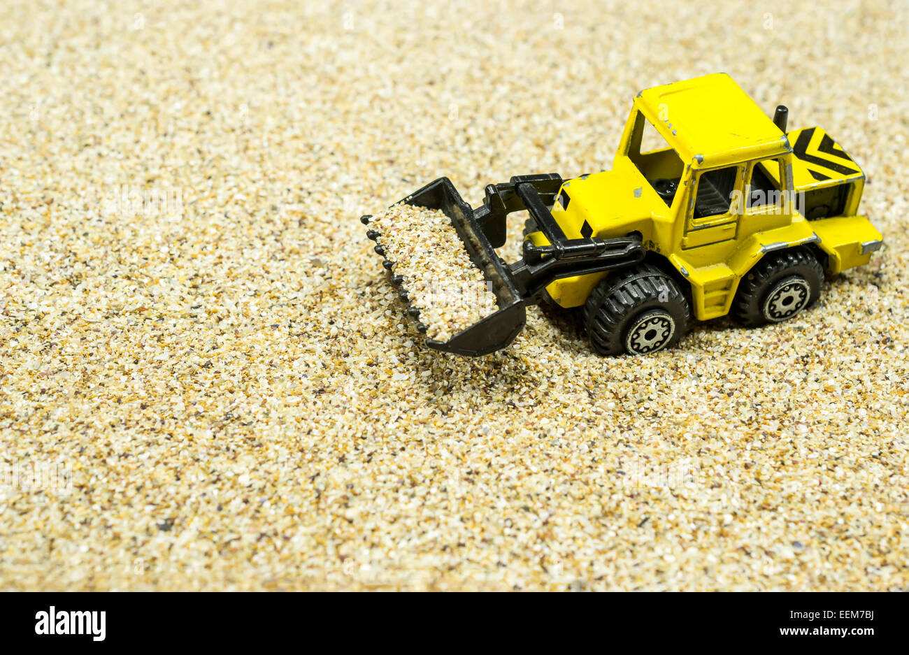 Front loader toy scale model with the front bucket full of sand Stock ...