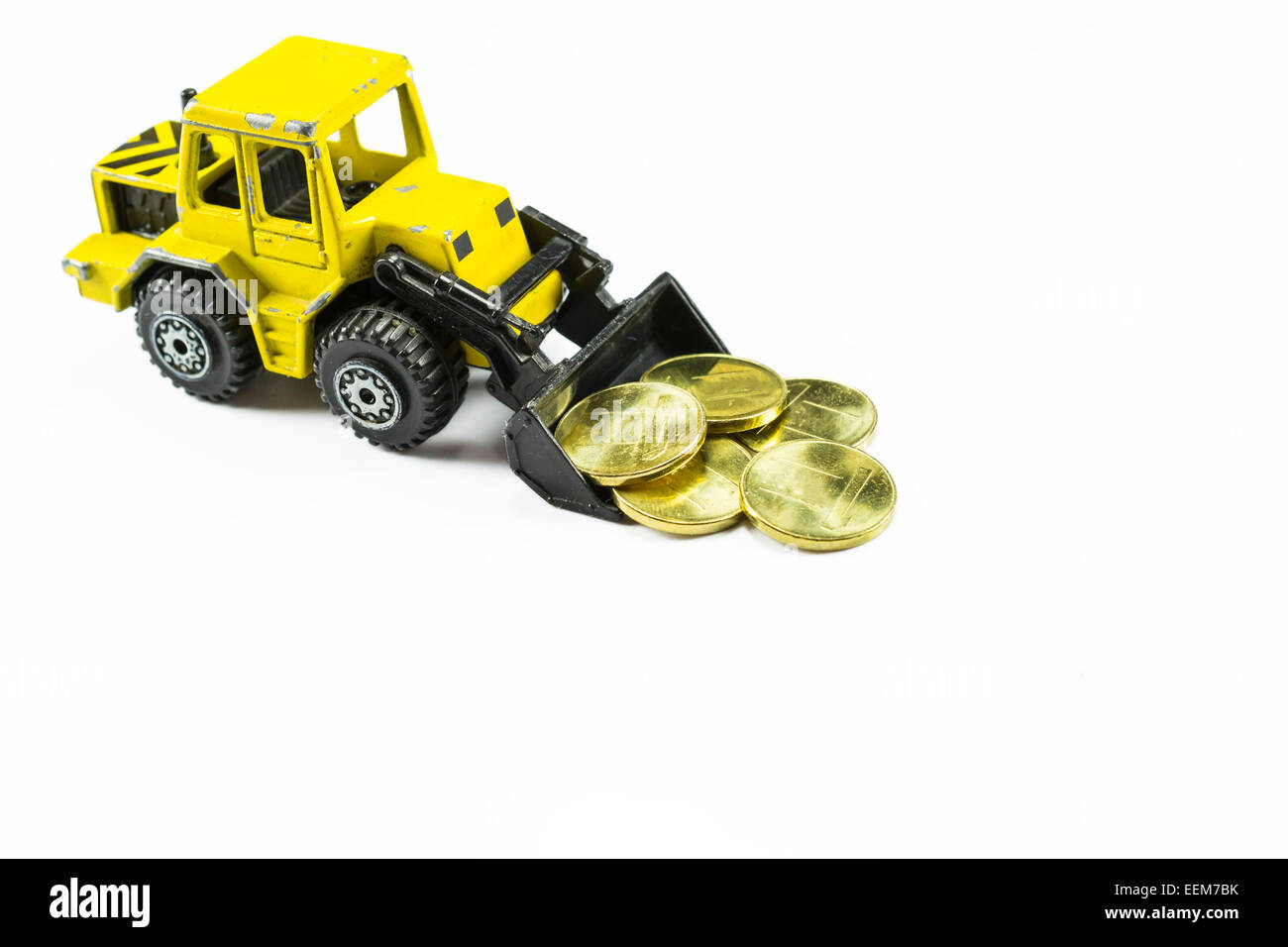 Scale model toy of a front loader construction machinery scooping money ...