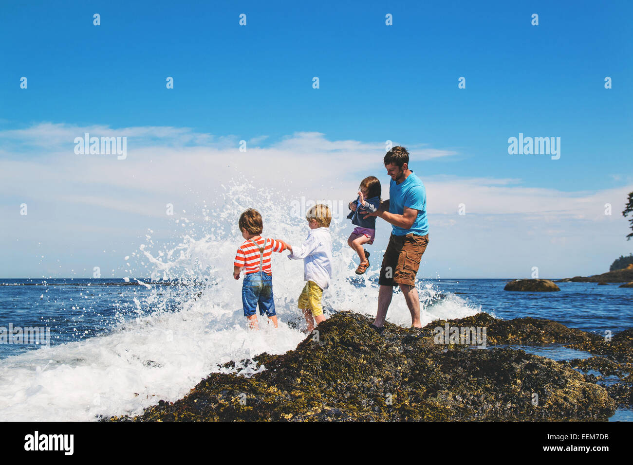 Children playing in the waves hi-res stock photography and images - Alamy