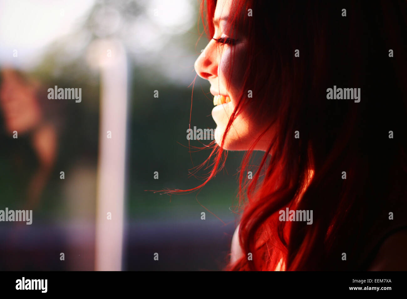 Portrait of a smiling woman looking out of window Stock Photo - Alamy