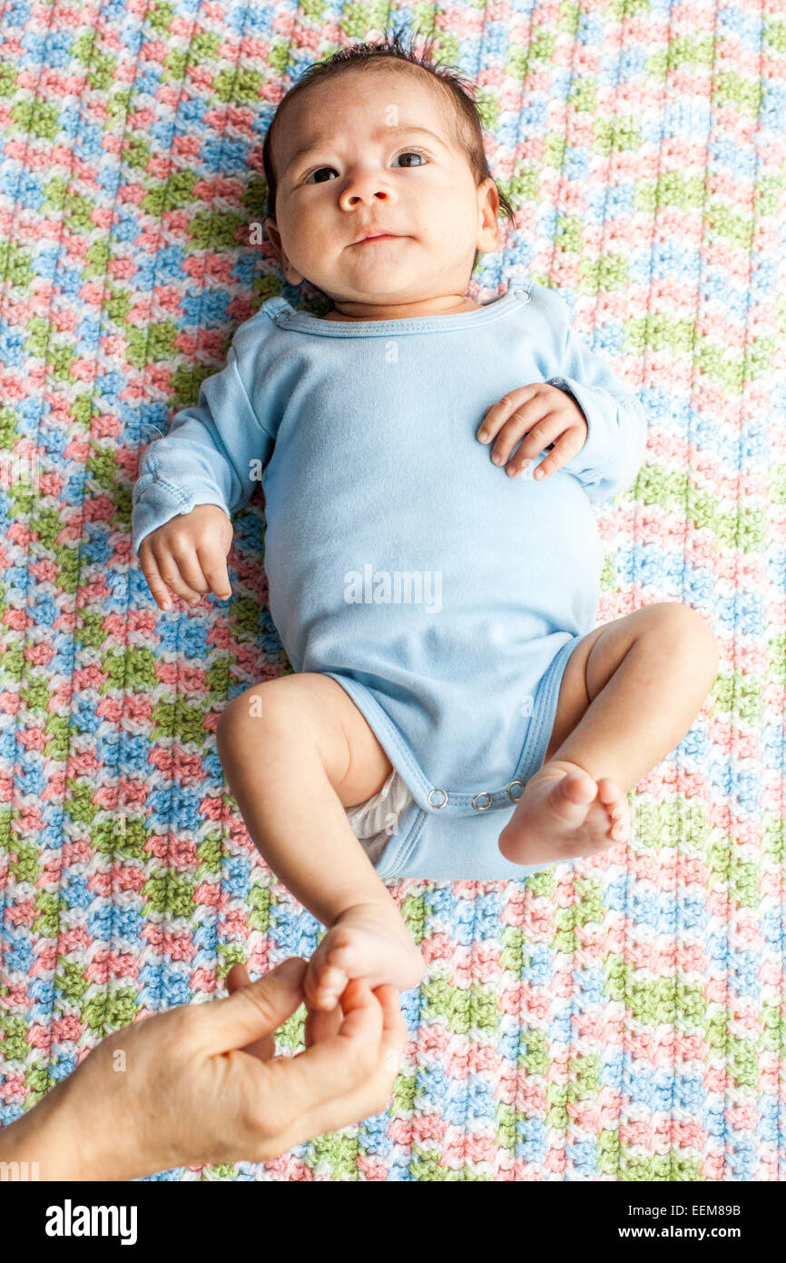 Mother tickling foot of baby boy Stock Photo - Alamy