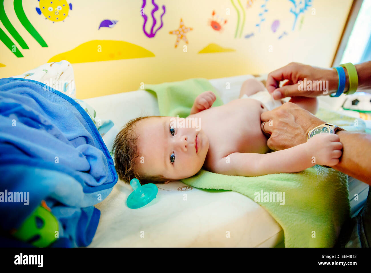 Caucasian father changing diaper of baby boy Stock Photo - Alamy