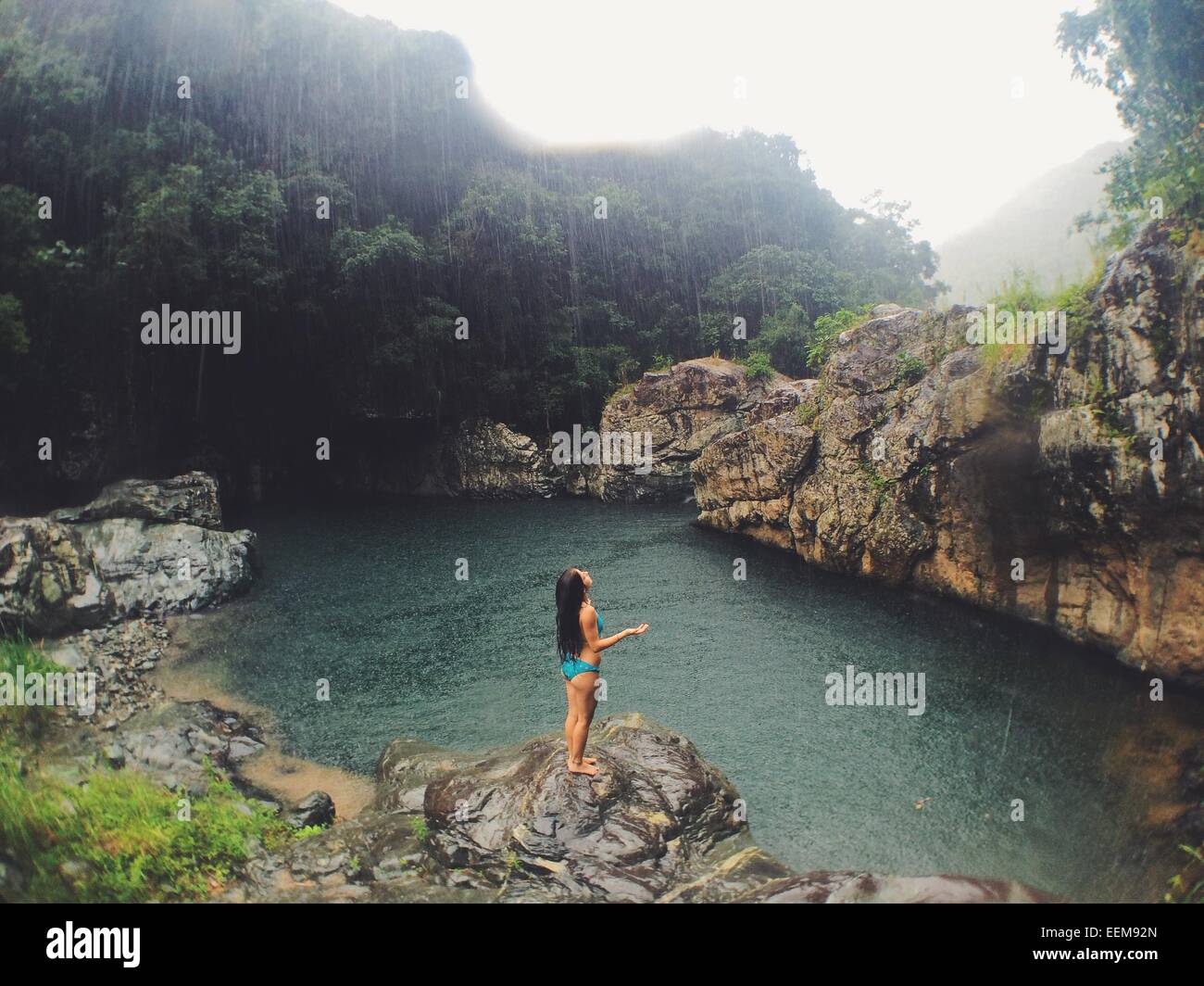 Woman standing on rock in rain Stock Photo - Alamy