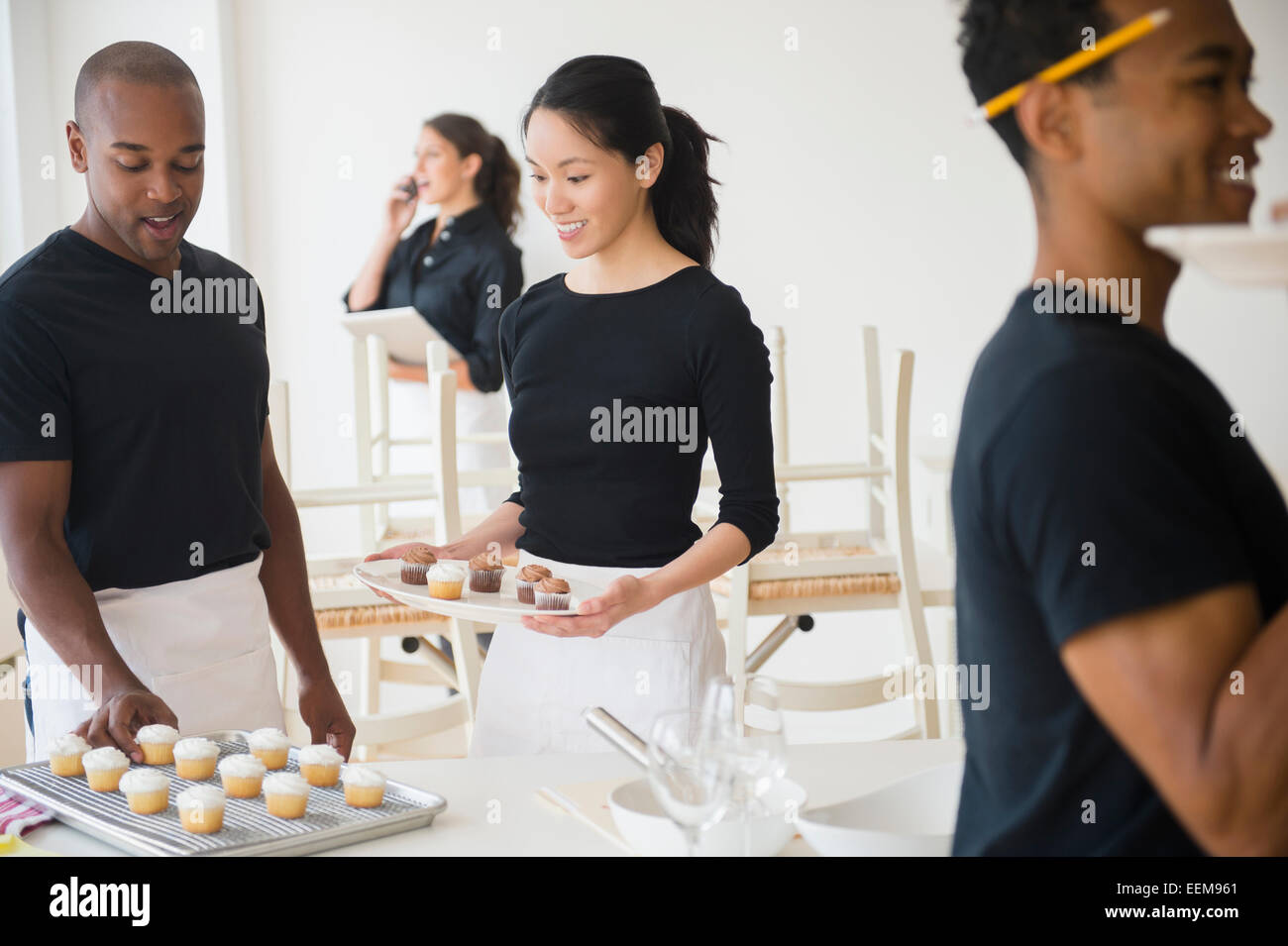 Caterers working together in event space Stock Photo - Alamy