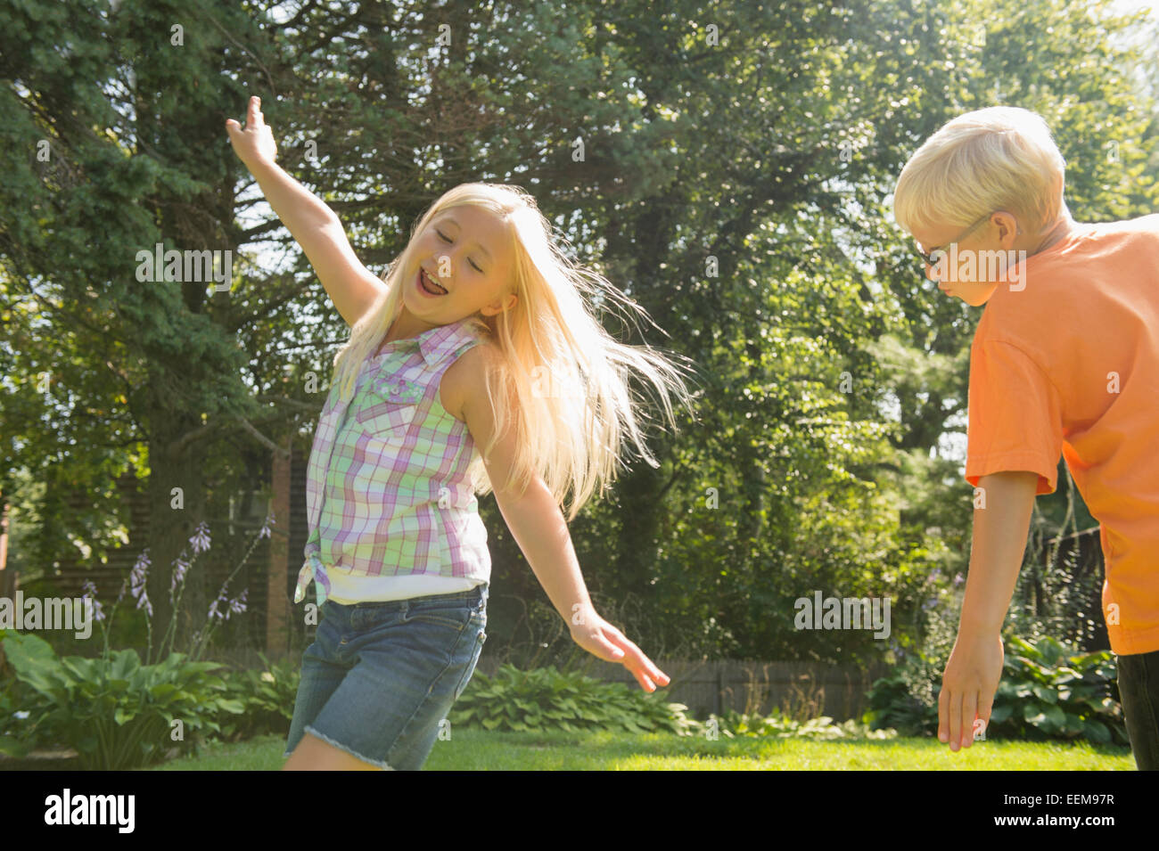 Caucasian children playing in backyard Stock Photo - Alamy