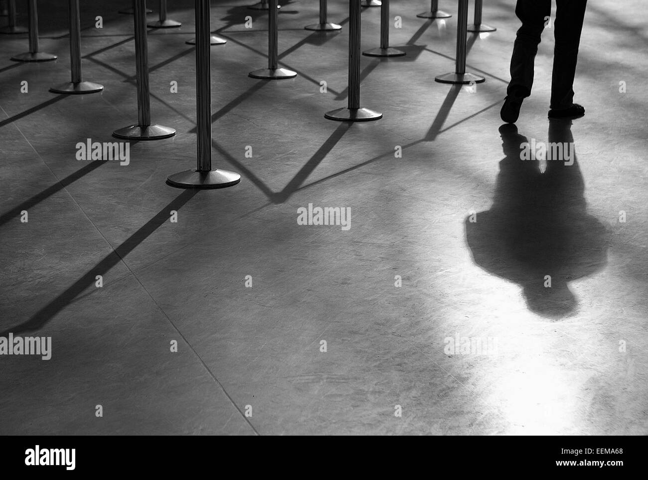 Shadow of man and roped-off barriers Stock Photo - Alamy